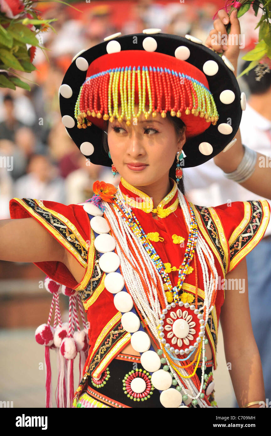 Li Hongqia of the Lisu ethnic minority displays her folk costumes at a ...