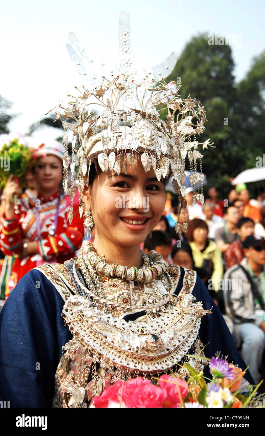 Tan Yan of the Sui ethnic minority displays her costumes at a grand ...