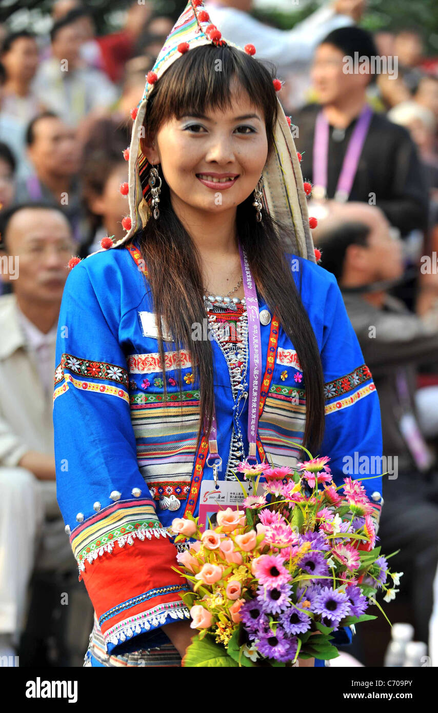 Dong Meilian of the Jino ethnic minority displays her folk costumes at ...