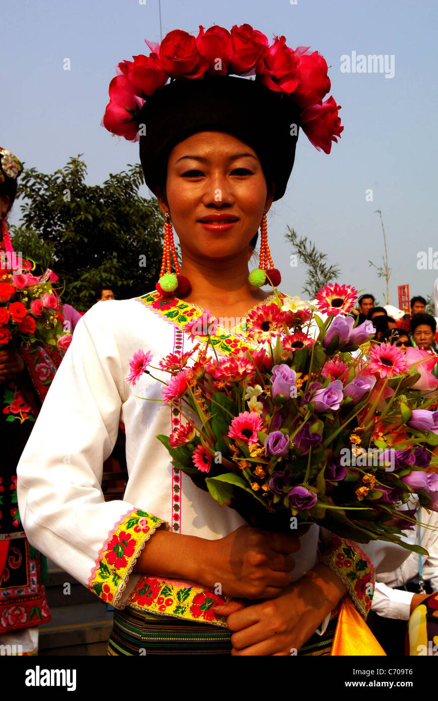 Yu Erjiao of the Blang ethnic minority displays her folk costumes at a ...