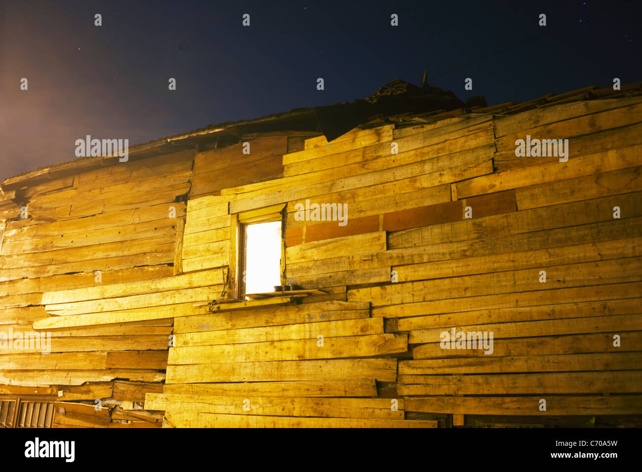 Lit window of wooden building Stock Photo - Alamy