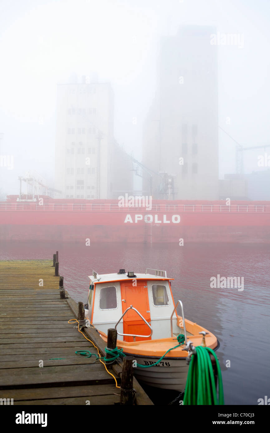 Tugboat docked in urban bay Stock Photo - Alamy