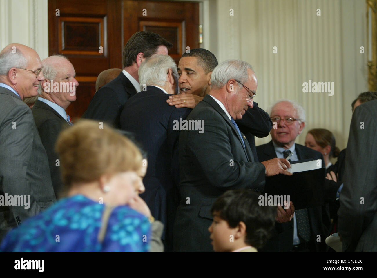 Congressional supporters congratulating President Obama after signing ...