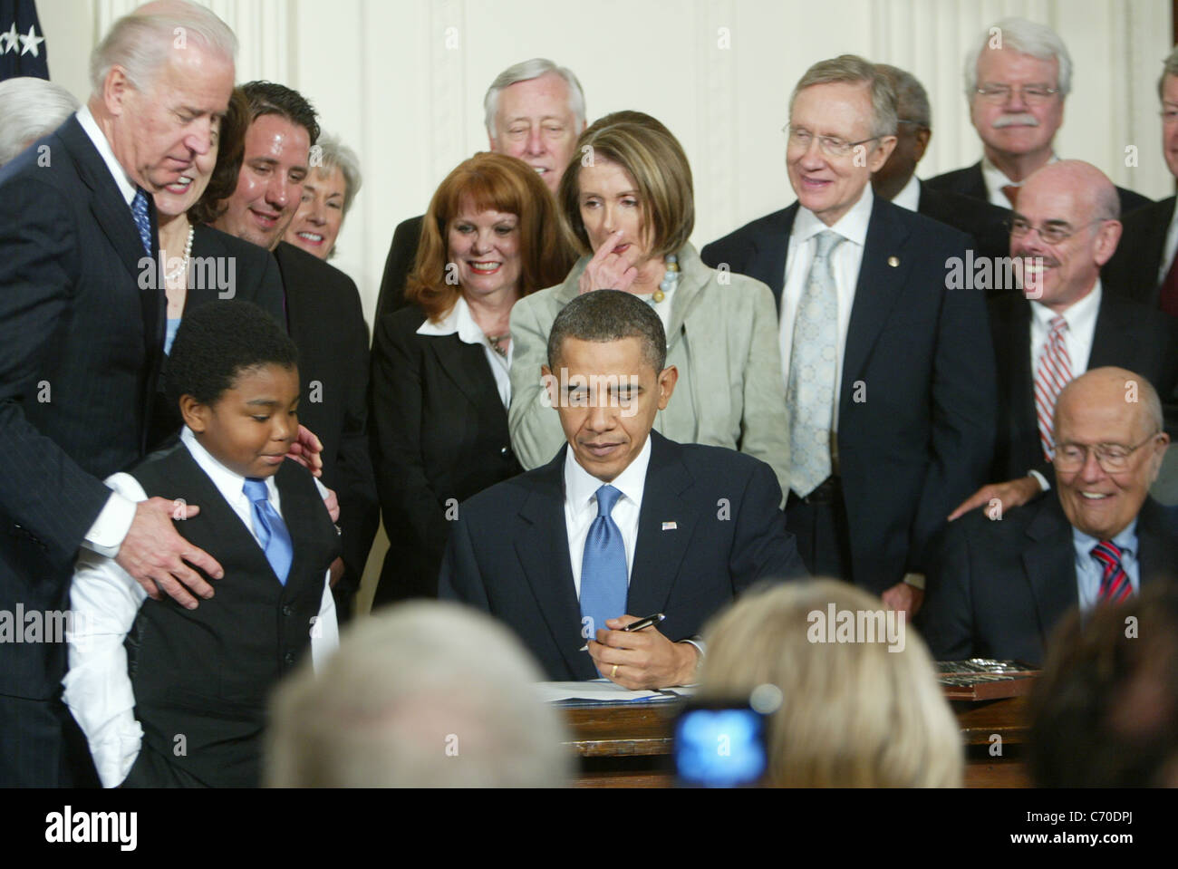 President Barack Obama signs the health insurance reform bill in the ...