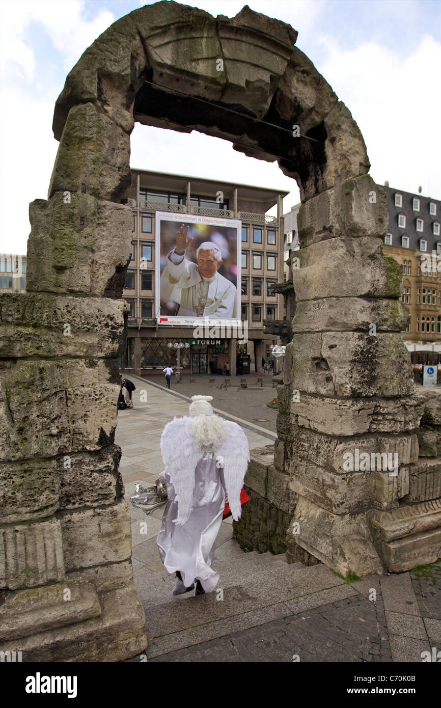 Performing Artist passing through Roman portal in Cologne. Huge Poster ...