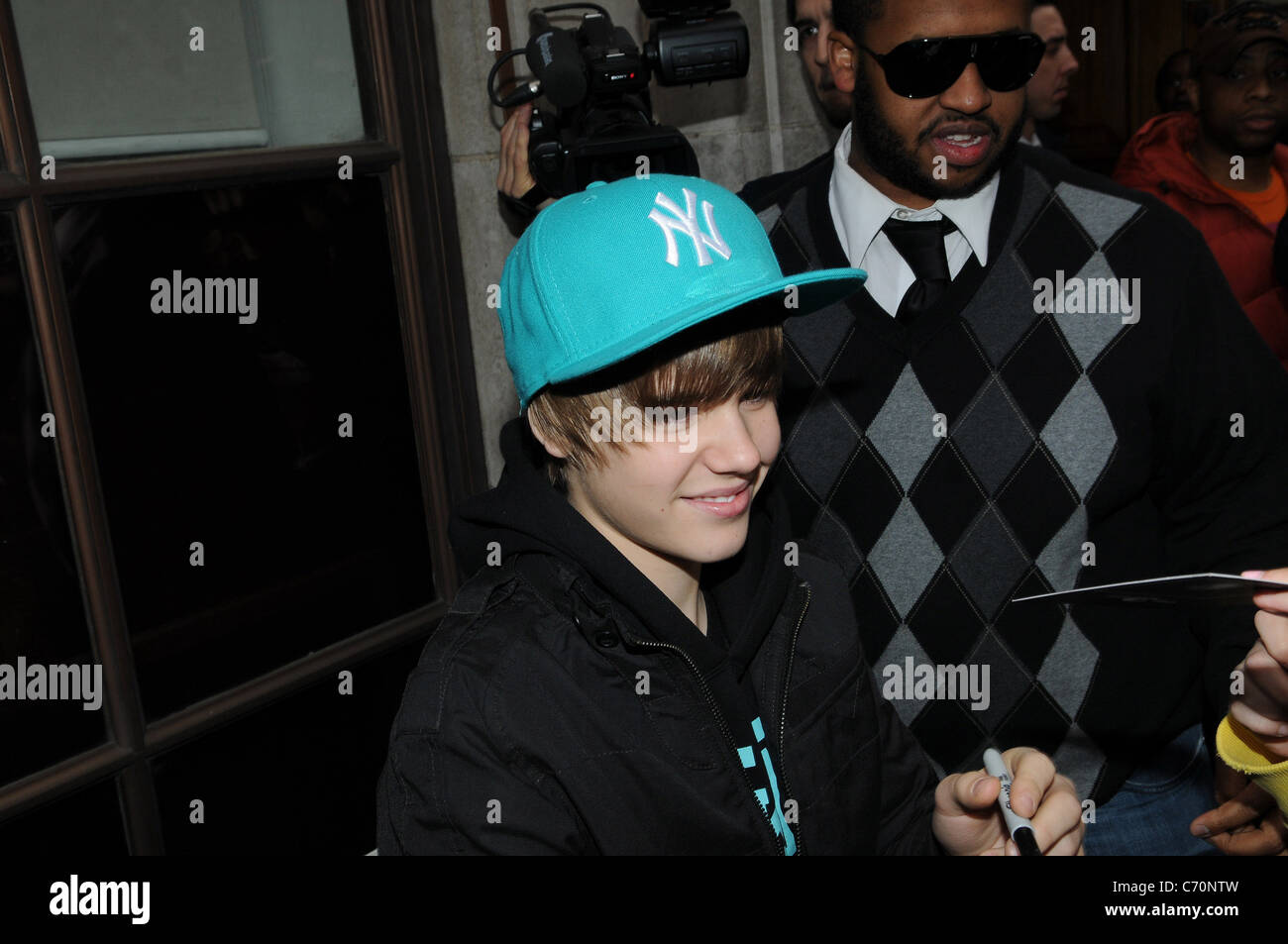 Justin bieber signing autographs outside the radio one studios london ...