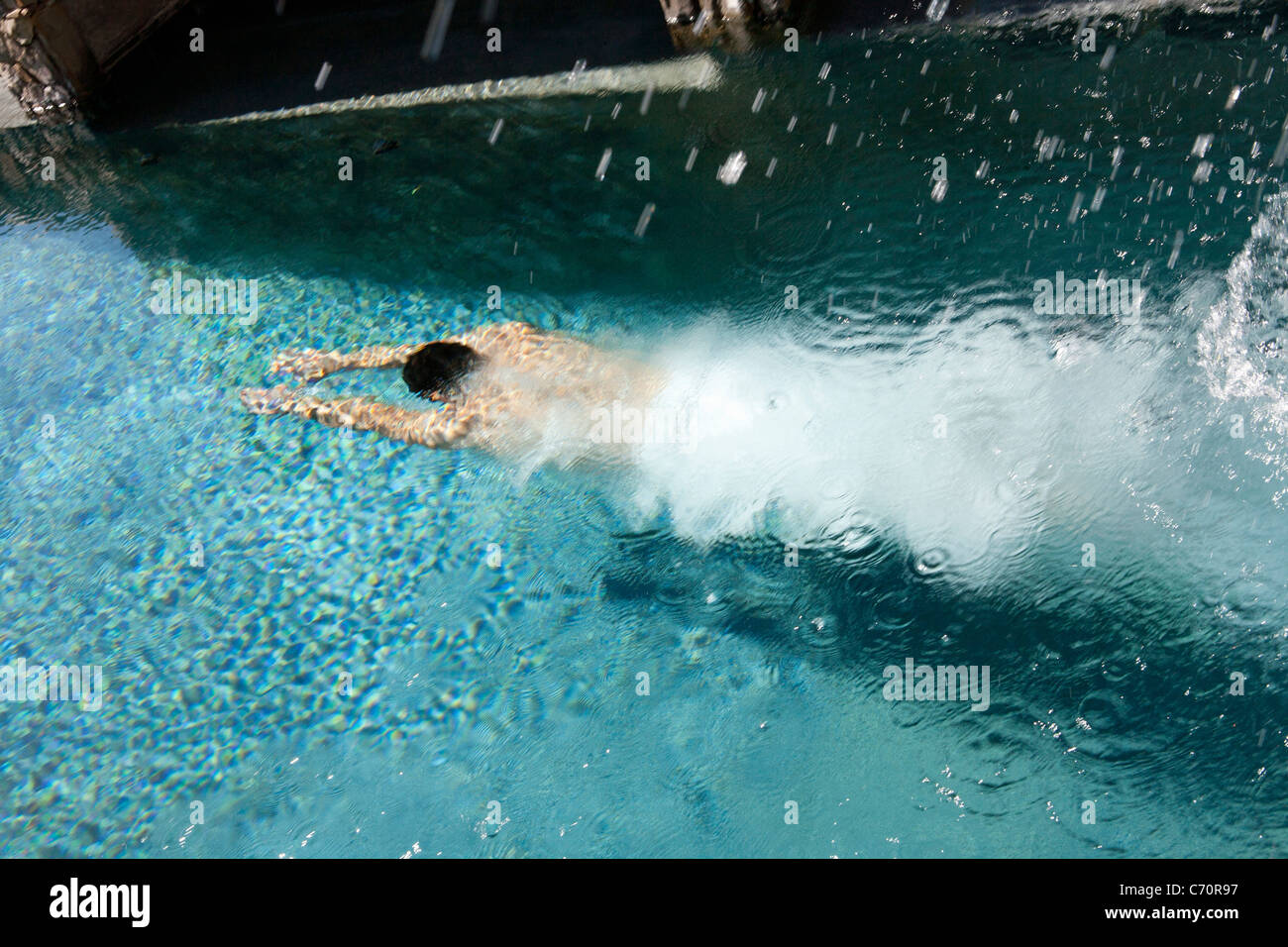 Woman diving into swimming pool Stock Photo - Alamy