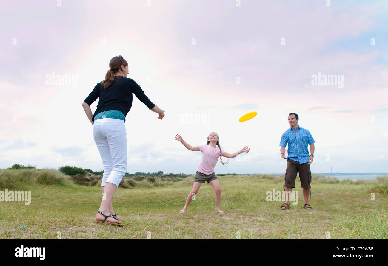 Family playing with frisbee outdoors Stock Photo - Alamy