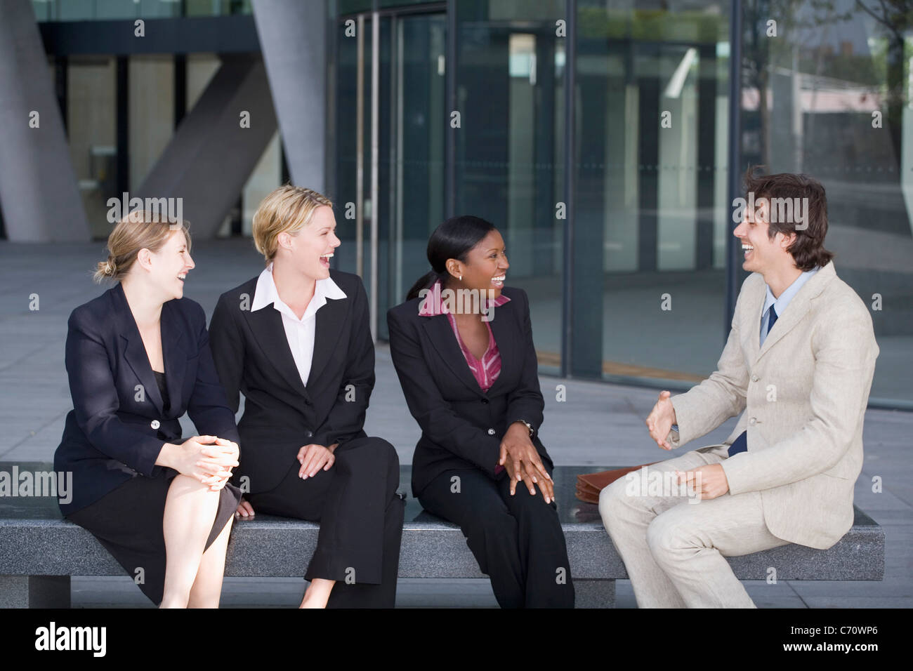 Business people talking on bench Stock Photo - Alamy