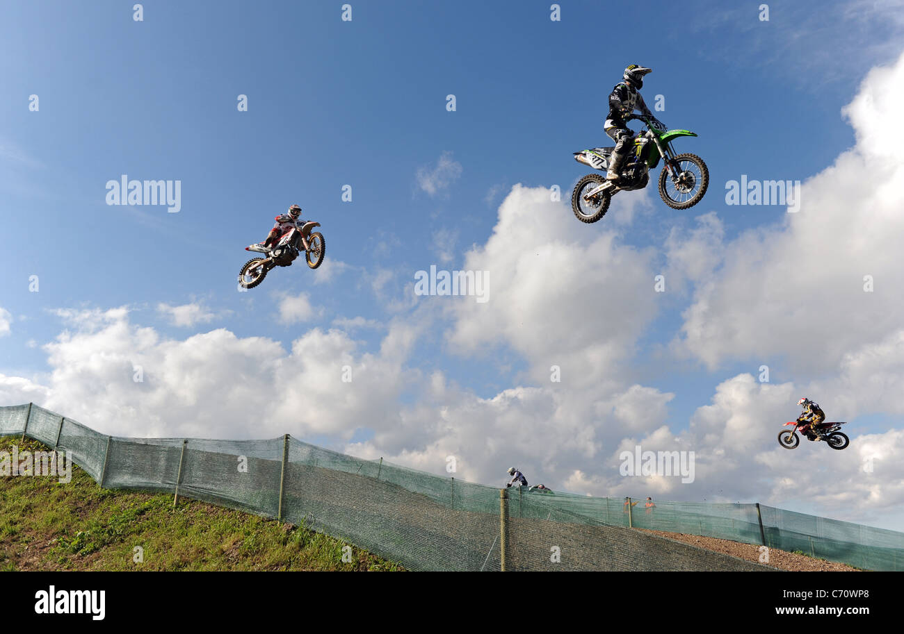 Motocross Racers jump through the air on MX Bikes Stock Photo - Alamy