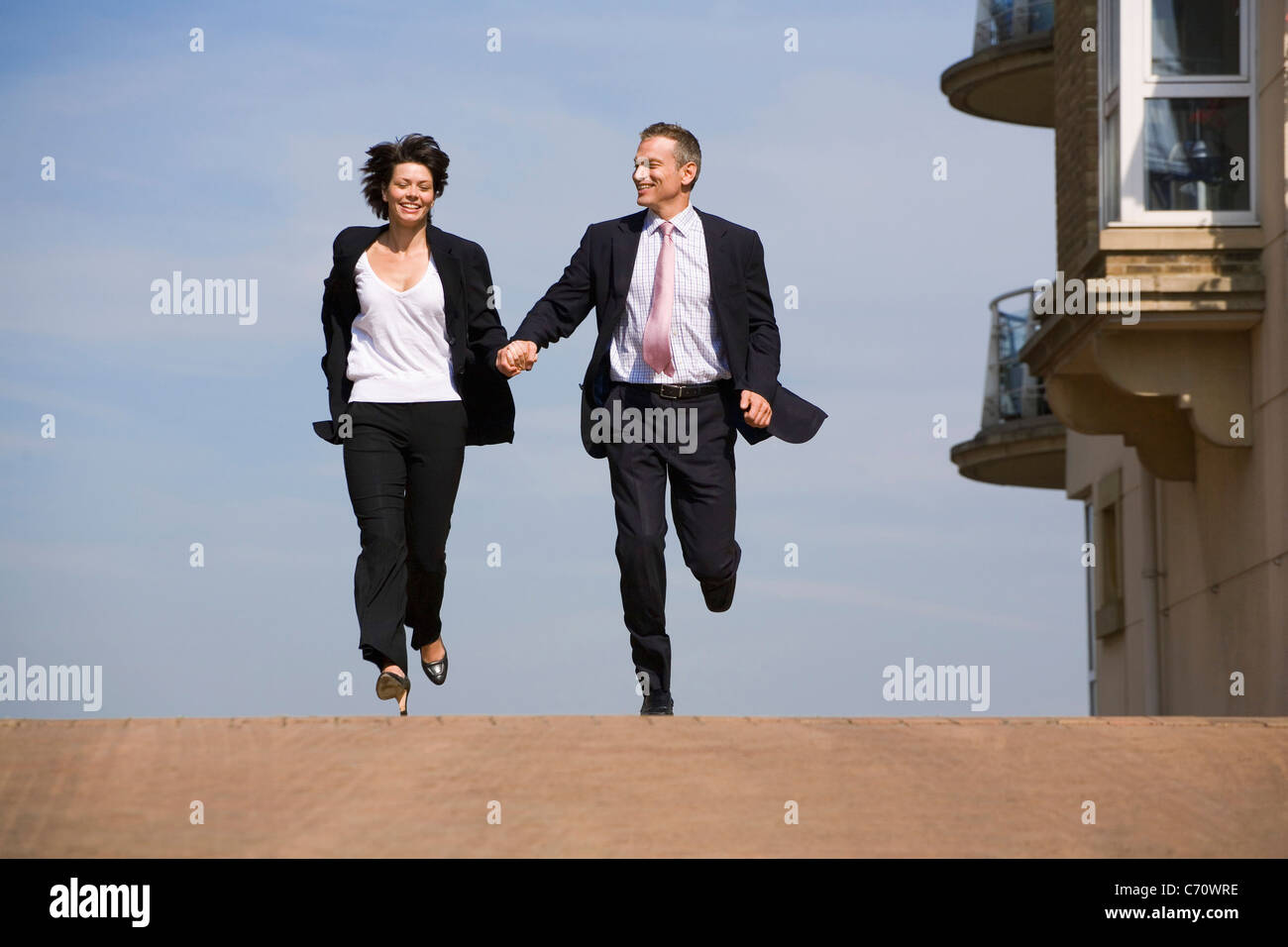Business people running on street Stock Photo - Alamy