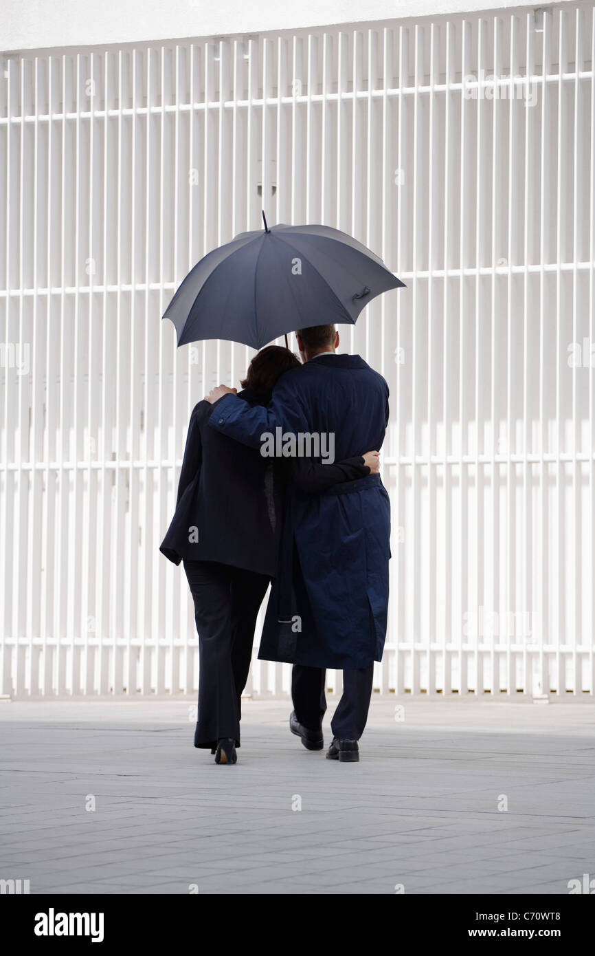 Women sharing umbrella hi-res stock photography and images - Alamy