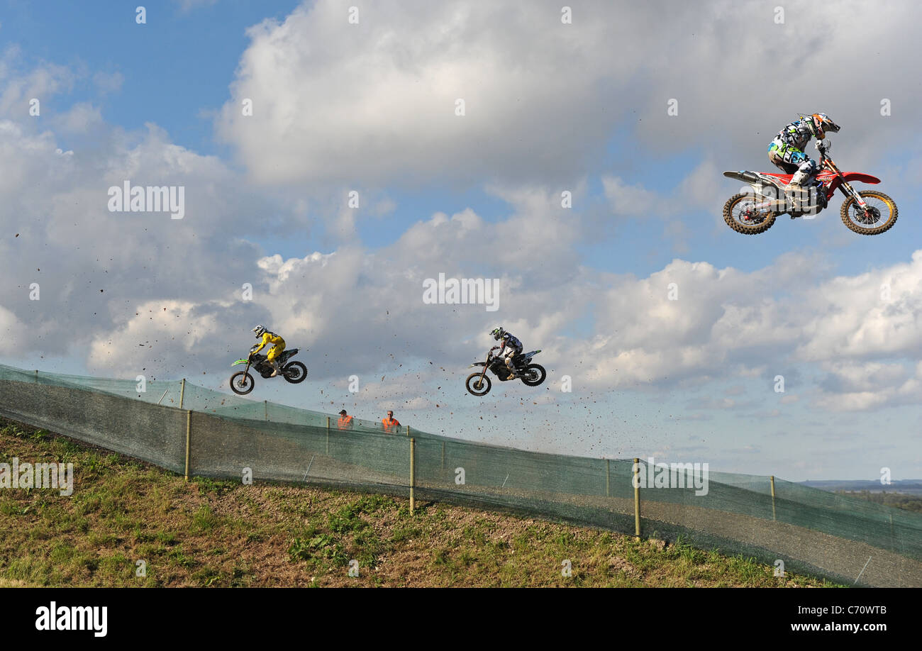 Motocross Racers jump through the air on MX Bikes Stock Photo - Alamy