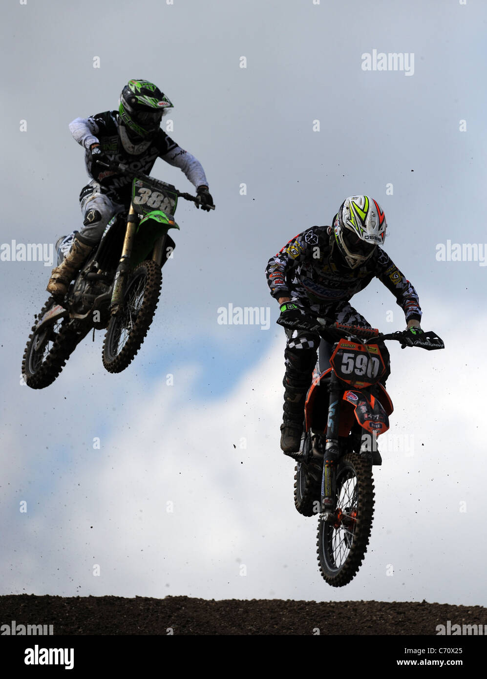 Motocross Racers jump through the air on MX Bikes Stock Photo - Alamy
