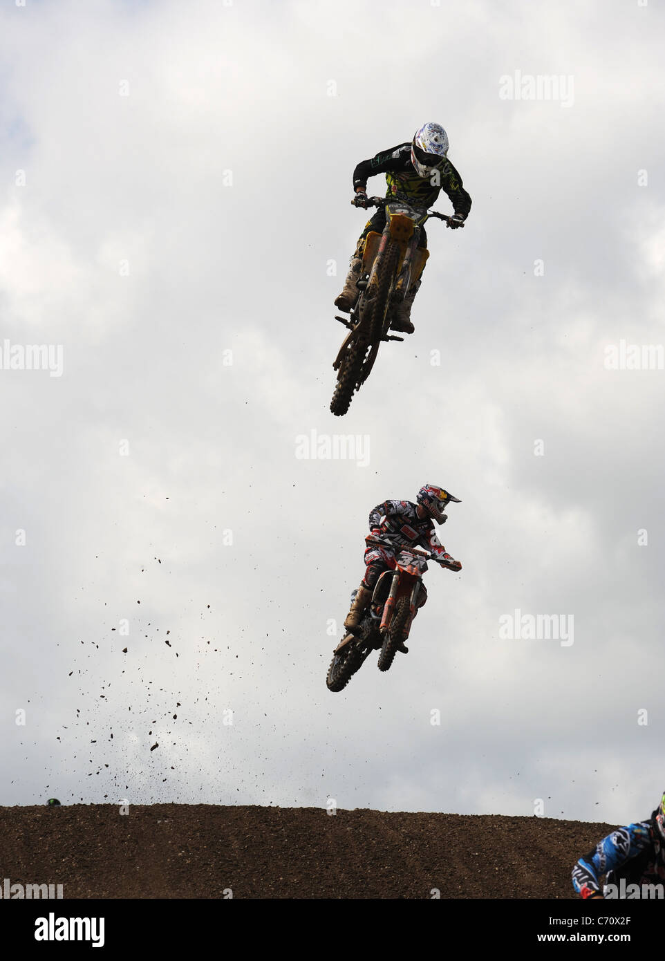 Motocross Racers jump through the air on MX Bikes Stock Photo - Alamy