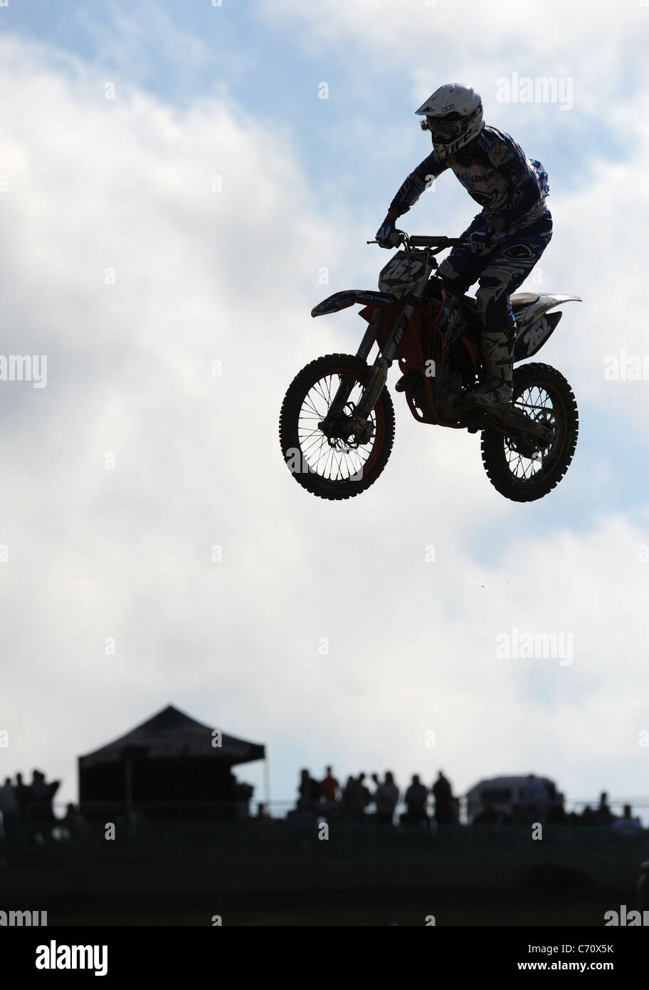 Silhouette motocross racer jumping on hi-res stock photography and ...