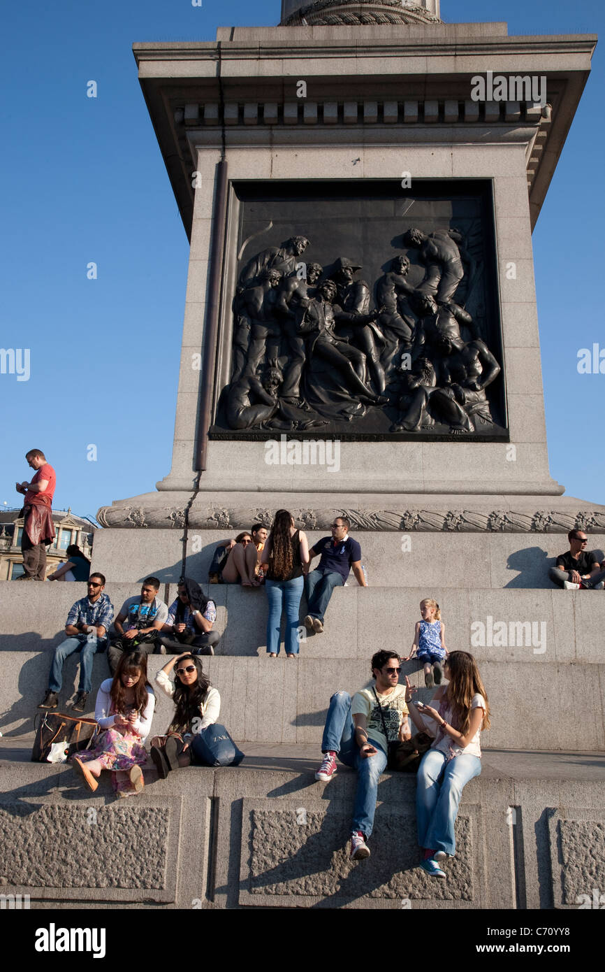 People resting at Nelsons Column; London, England, UK Stock Photo - Alamy
