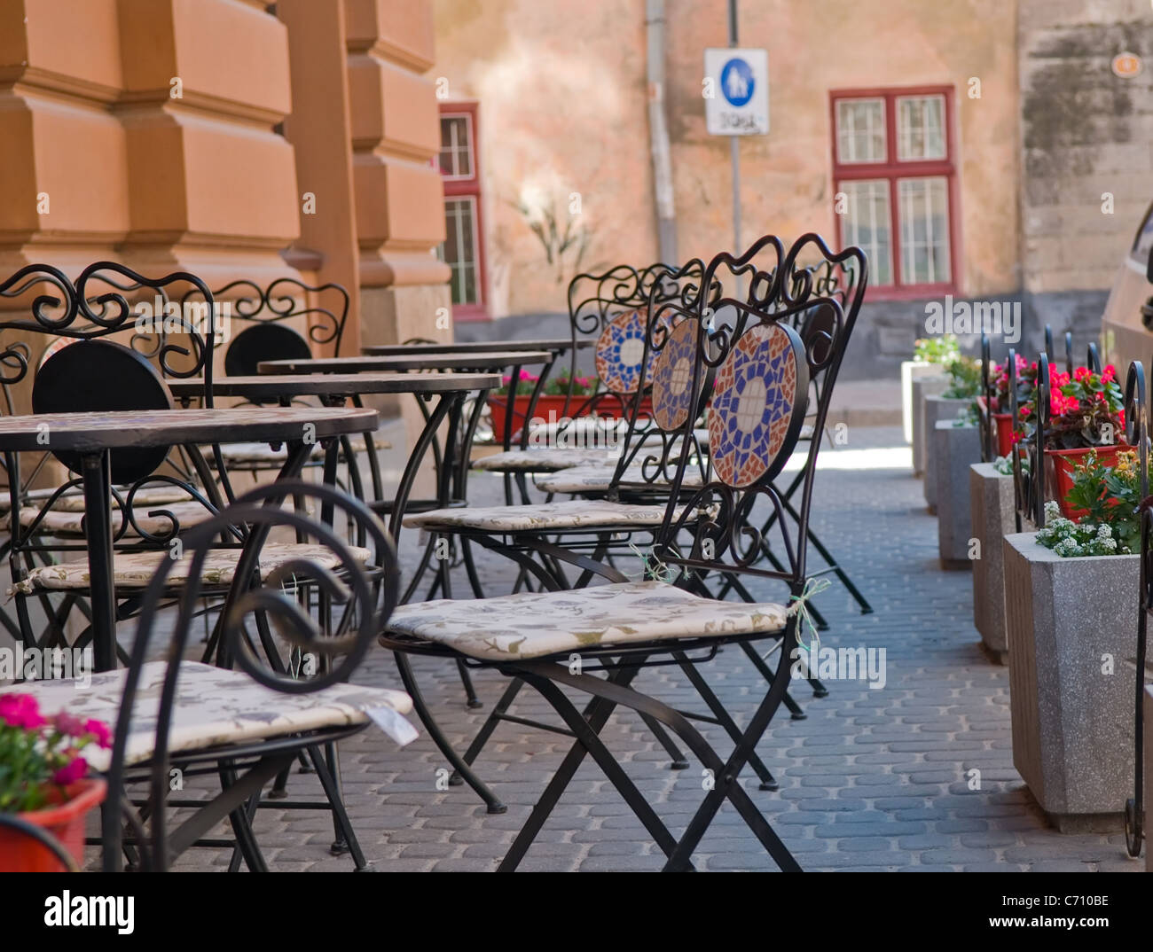 Small cafe in the street an old city. Tables and beautiful chairs on ...