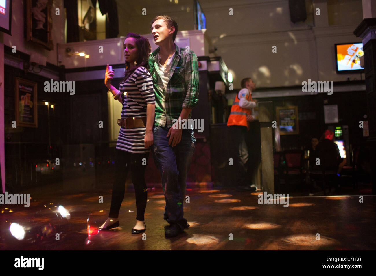 A young couple dances in a night club on a night out in Blackpool ...