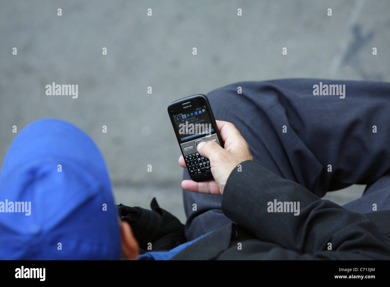 Looking down on a man sitting down and using his mobile phone Stock ...