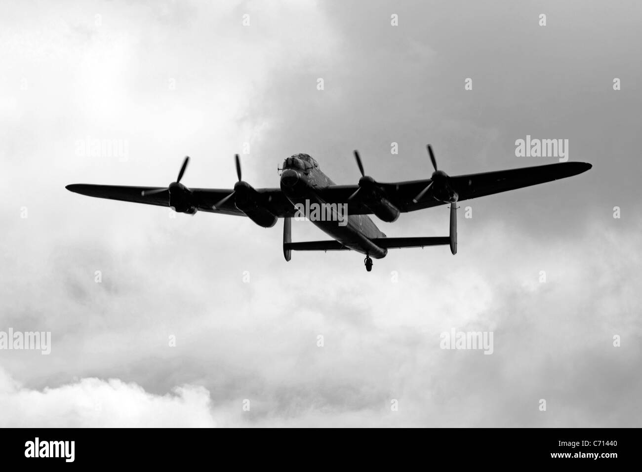 B/W WW2 British RAF Avro Lancaster Bomber Plane on a pass over an ...