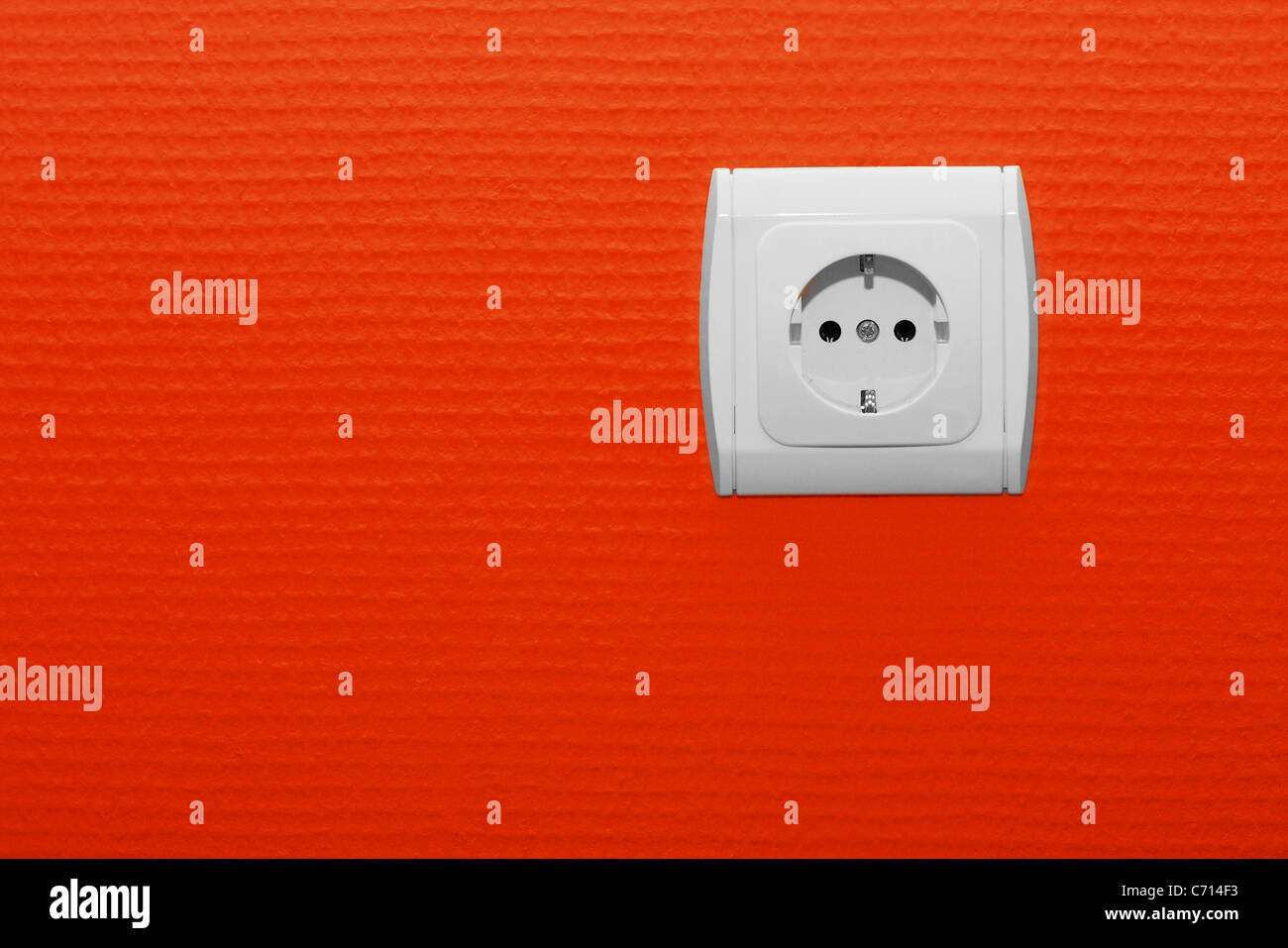 Electric socket with red wall background Stock Photo - Alamy