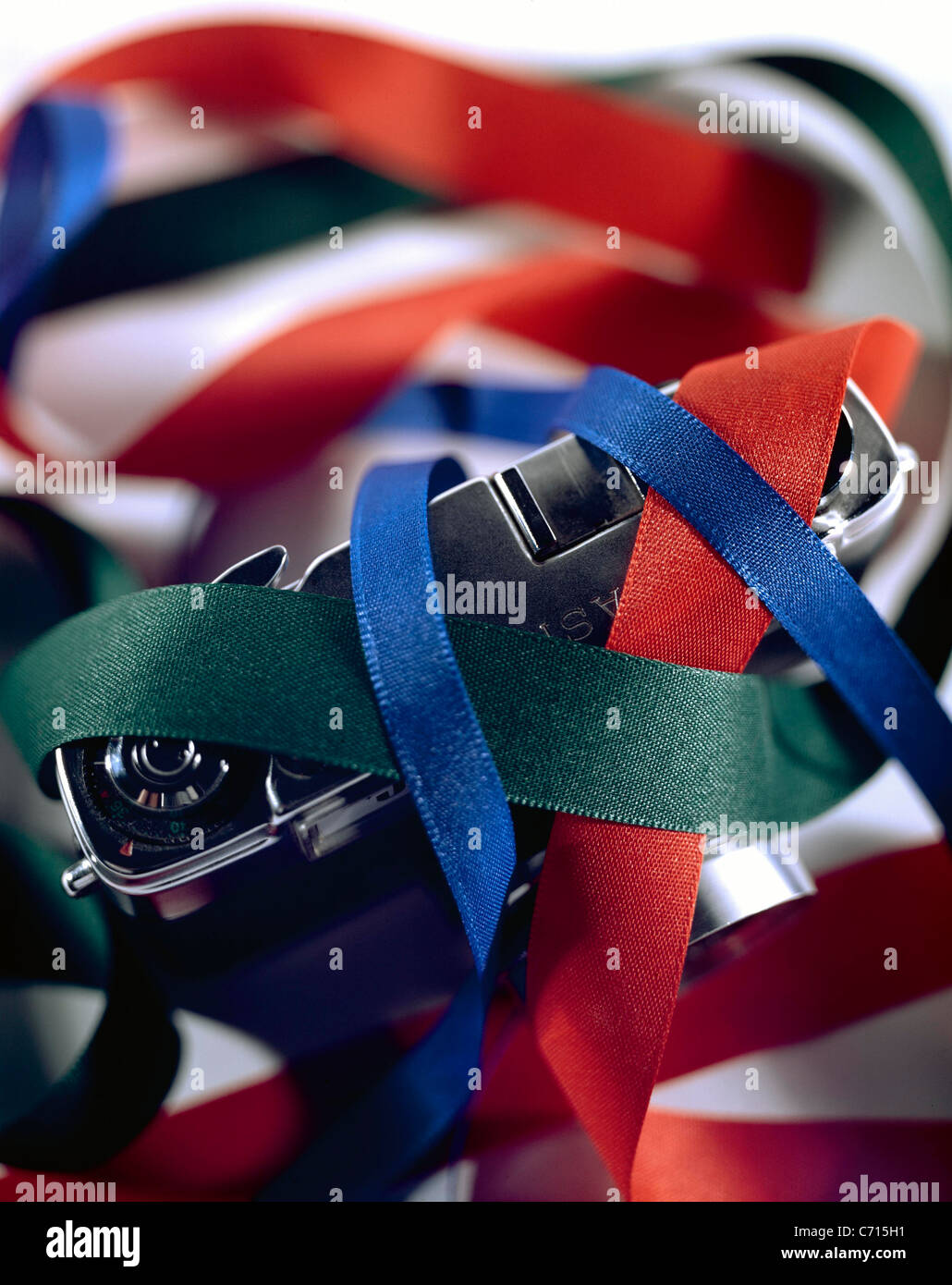 Old style film camera covered in ribbons representing the primary ...