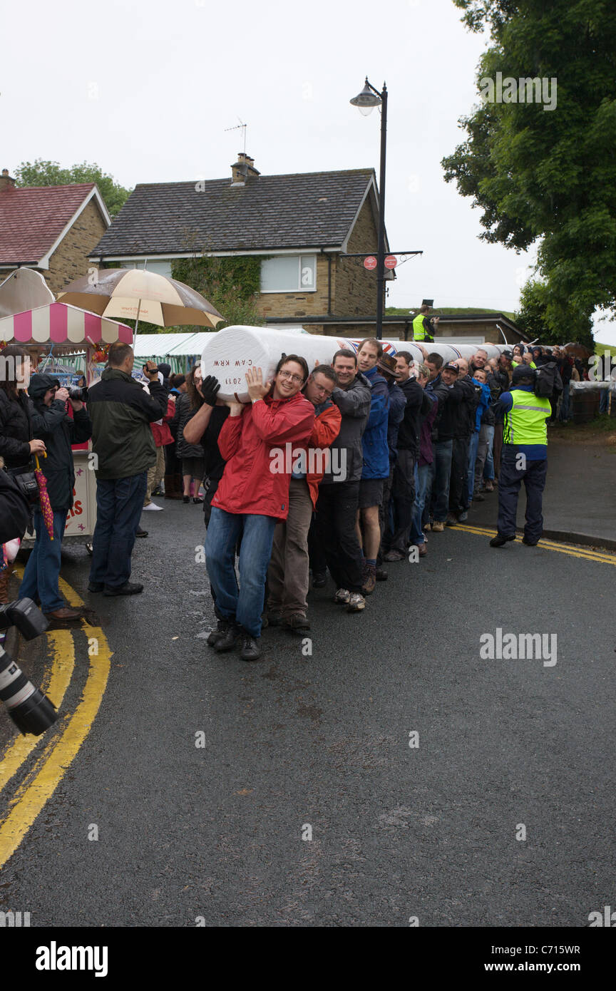 The newly decorated Maypole being put back into position at the center ...