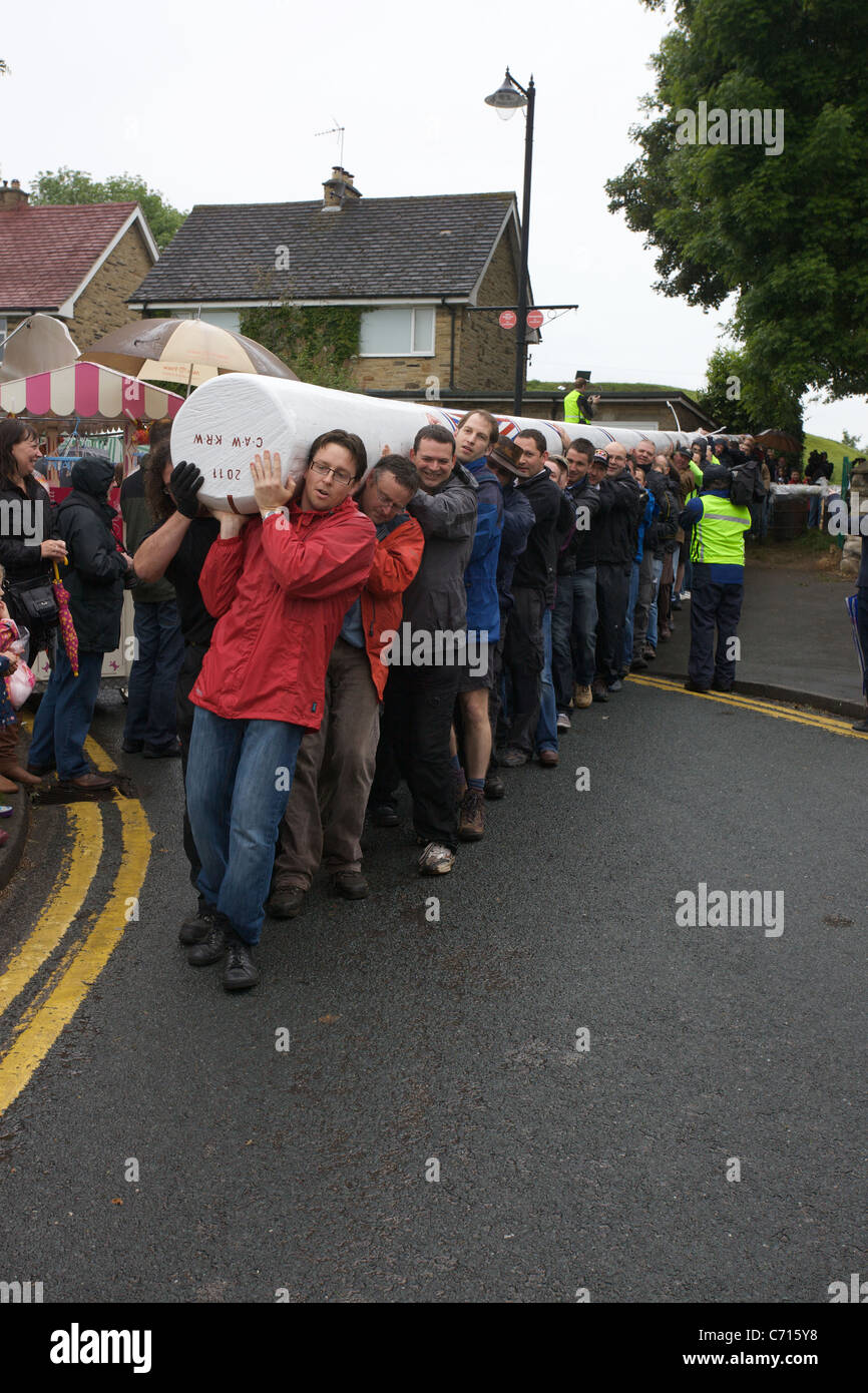 The newly decorated Maypole being put back into position at the center ...