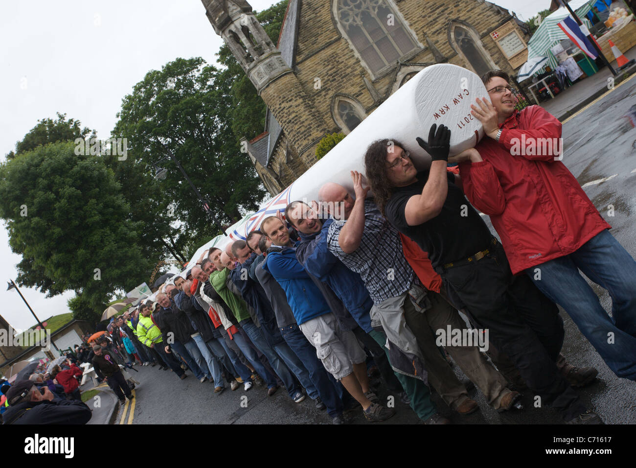 The newly decorated Maypole being put back into position at the center ...
