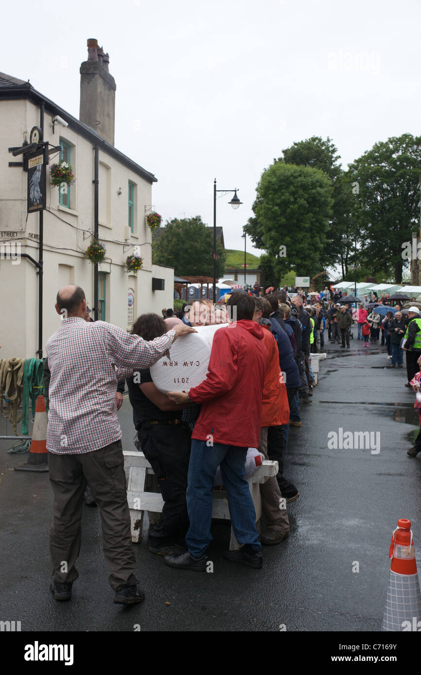 The newly decorated Maypole being put back into position at the center ...
