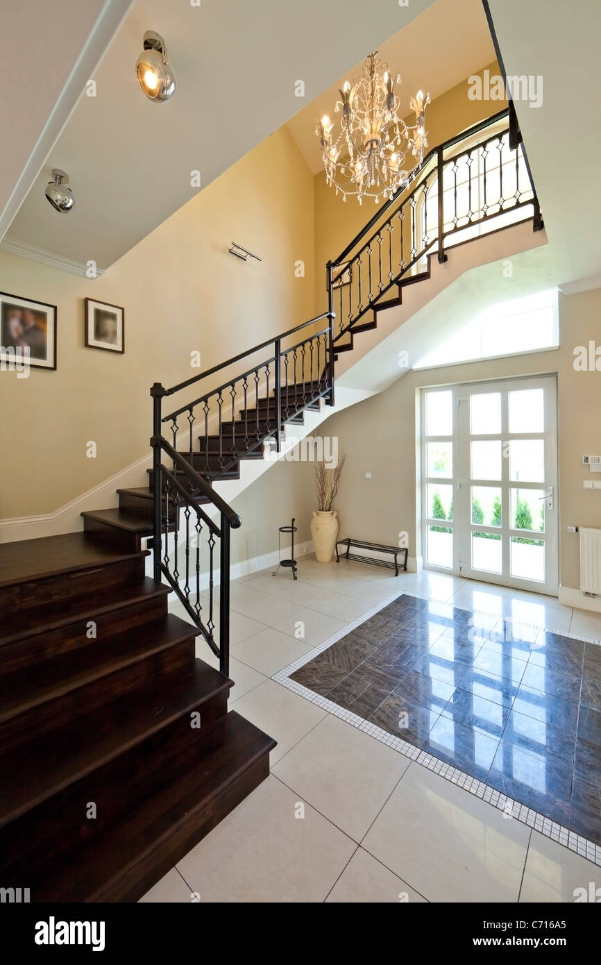 Modern entrance hall w stairway and banister Stock Photo - Alamy
