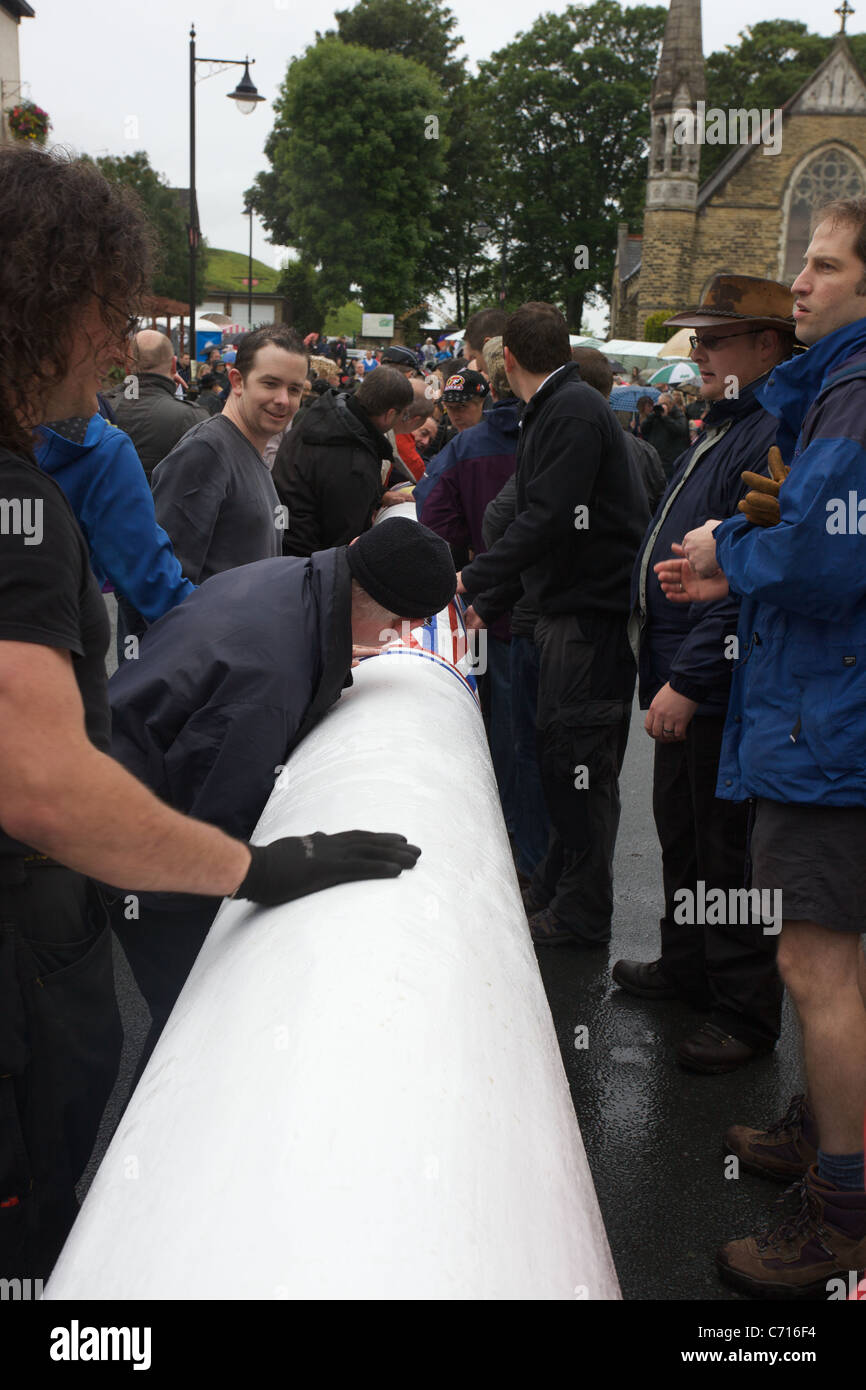 The newly decorated Maypole being put back into position at the center ...