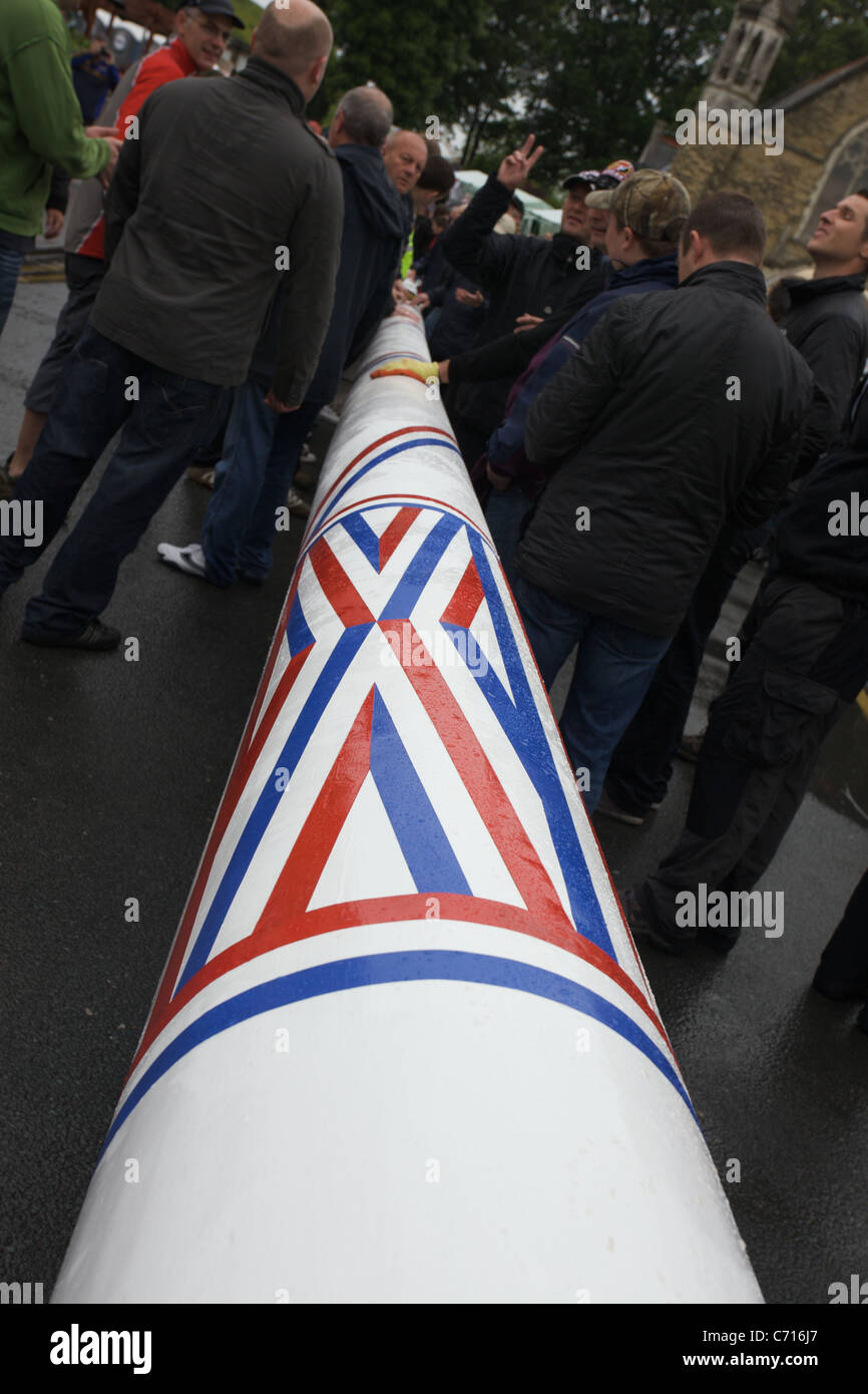 The newly decorated Maypole being put back into position at the center ...