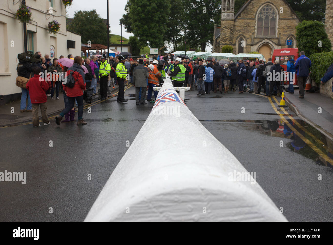 The newly decorated Maypole being put back into position at the center ...