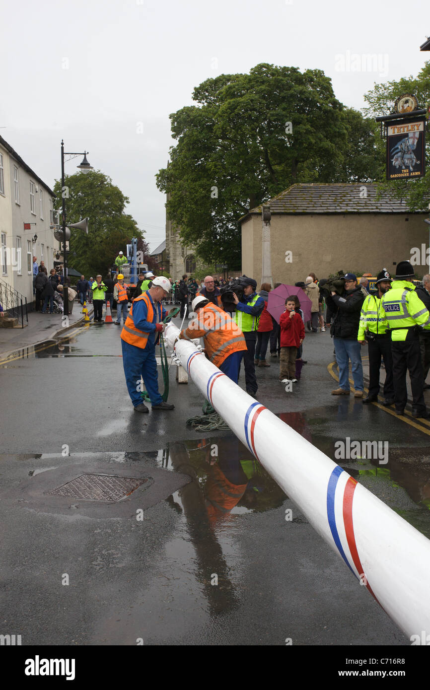 The newly decorated Maypole being put back into position at the center ...