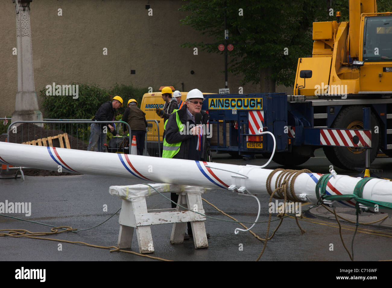 The newly decorated Maypole being put back into position at the center ...