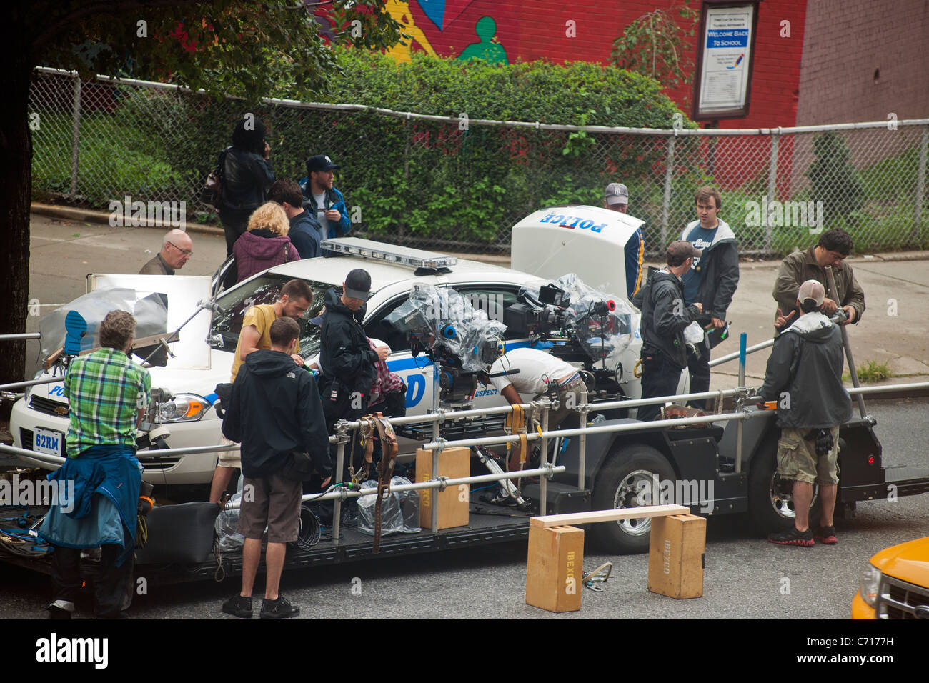 A production crew prepares an NYPD police car on a trailer for a shot ...