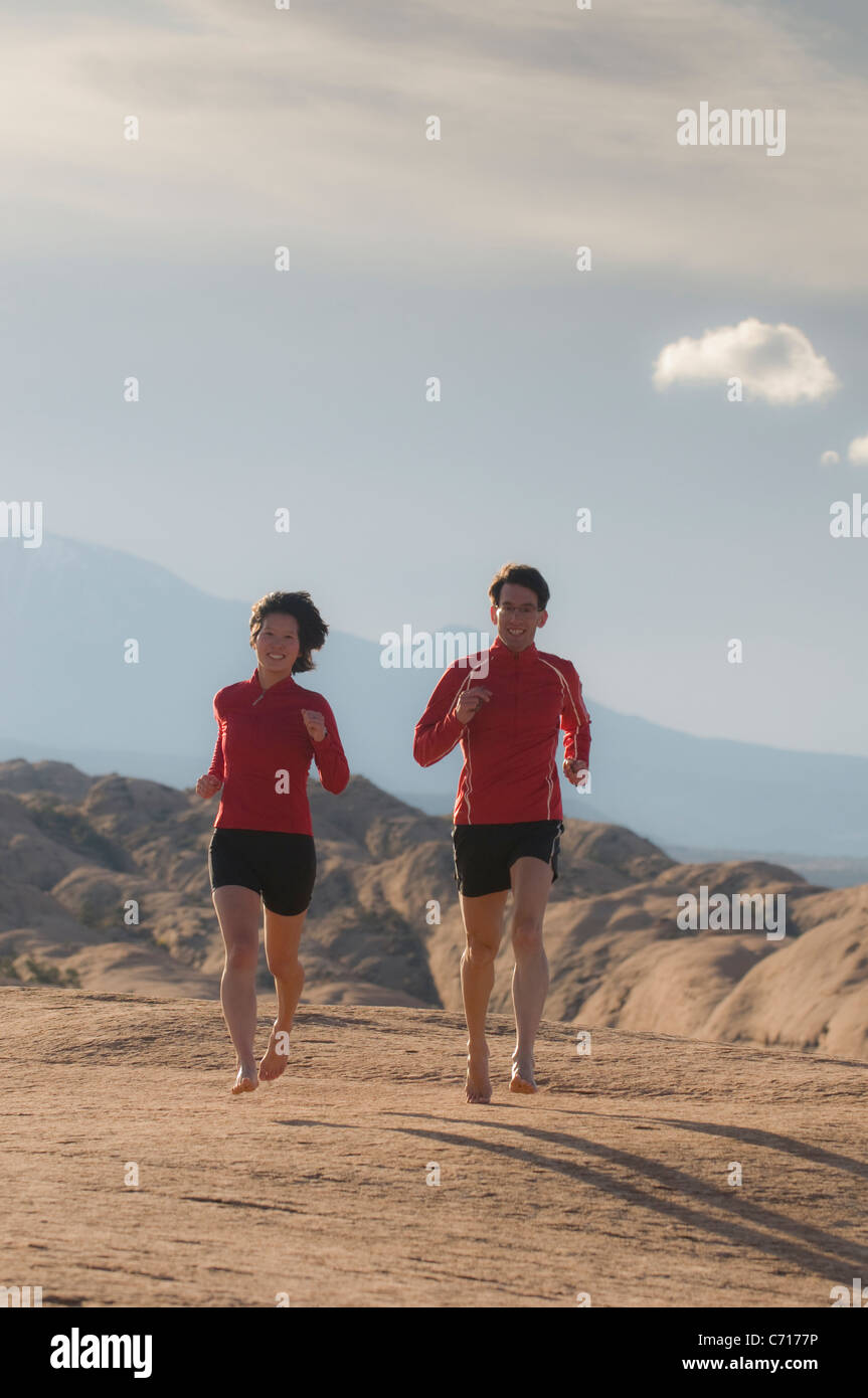 Man and woman barefoot running in Moab, Utah Stock Photo - Alamy