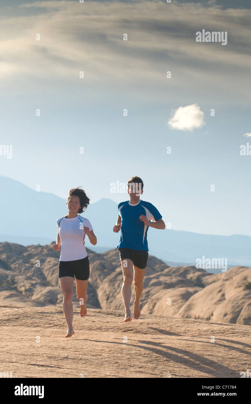 Man and woman barefoot running in Moab, Utah Stock Photo - Alamy