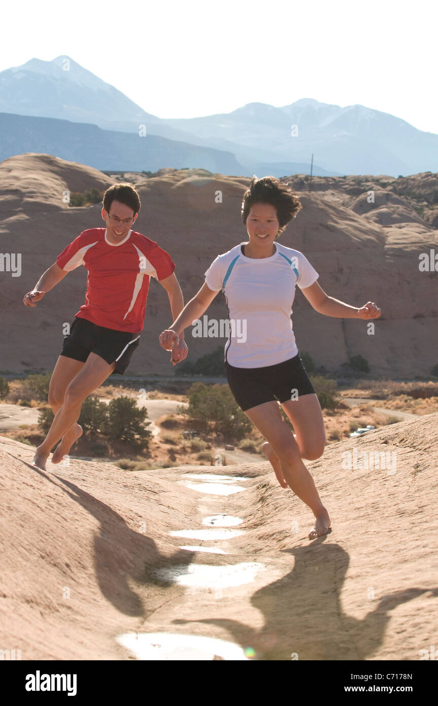 Man and woman barefoot running in Moab, Utah Stock Photo - Alamy