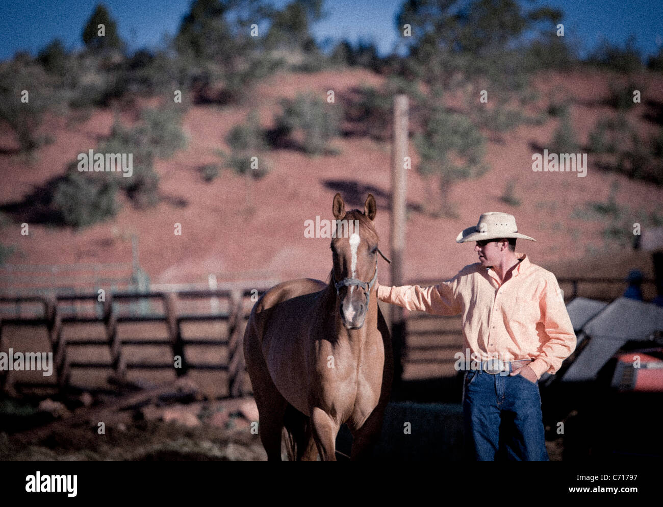 Cowboy standing next to his horse Stock Photo - Alamy