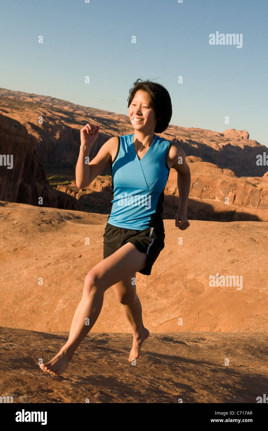 Woman barefoot running on sandstone, Moab, Utah Stock Photo - Alamy