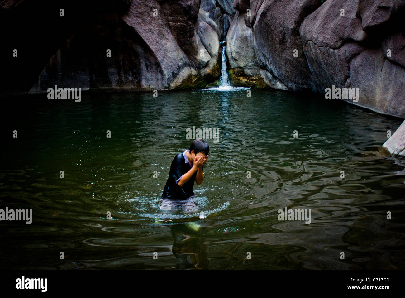 Happy young boy coming out of river Stock Photo - Alamy