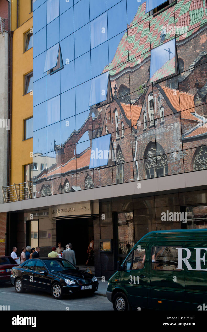 Church reflection seen on the glass wall of the modern building in ...