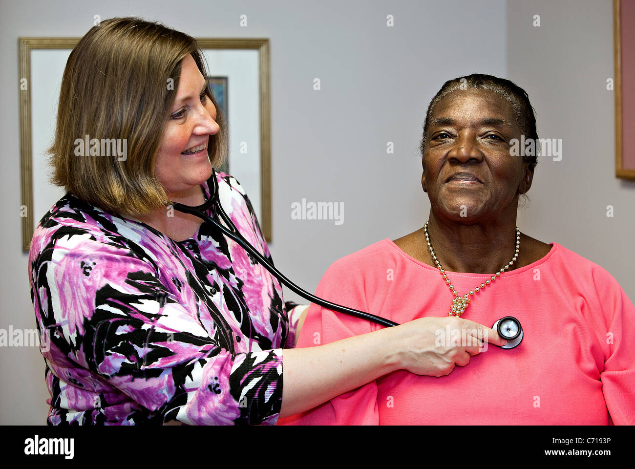 A doctor checks over a patient in a hospital room Stock Photo - Alamy