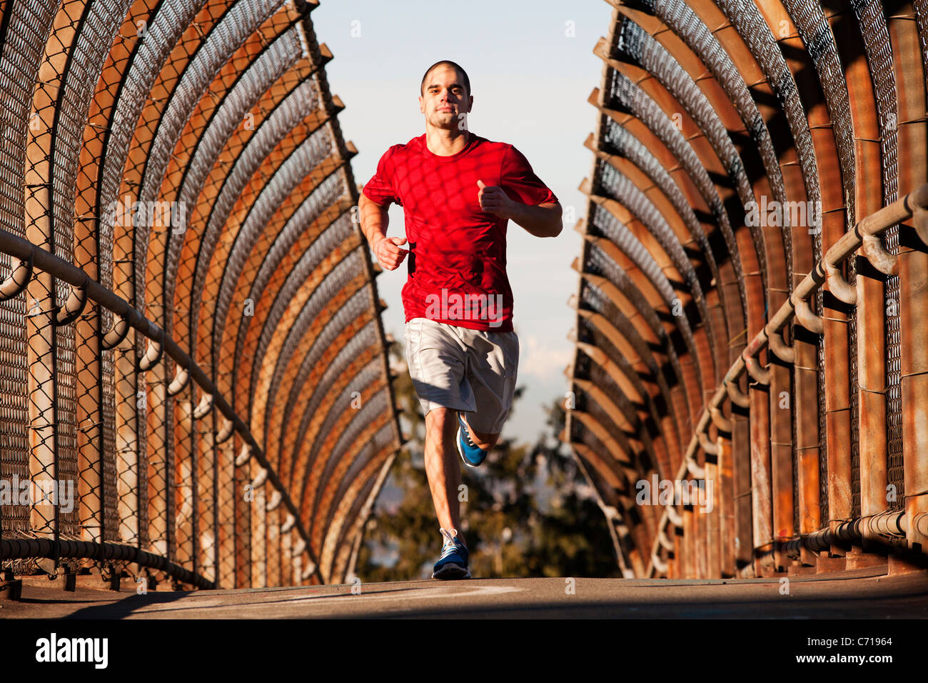 A healthy man runs on an urban pathway Stock Photo - Alamy