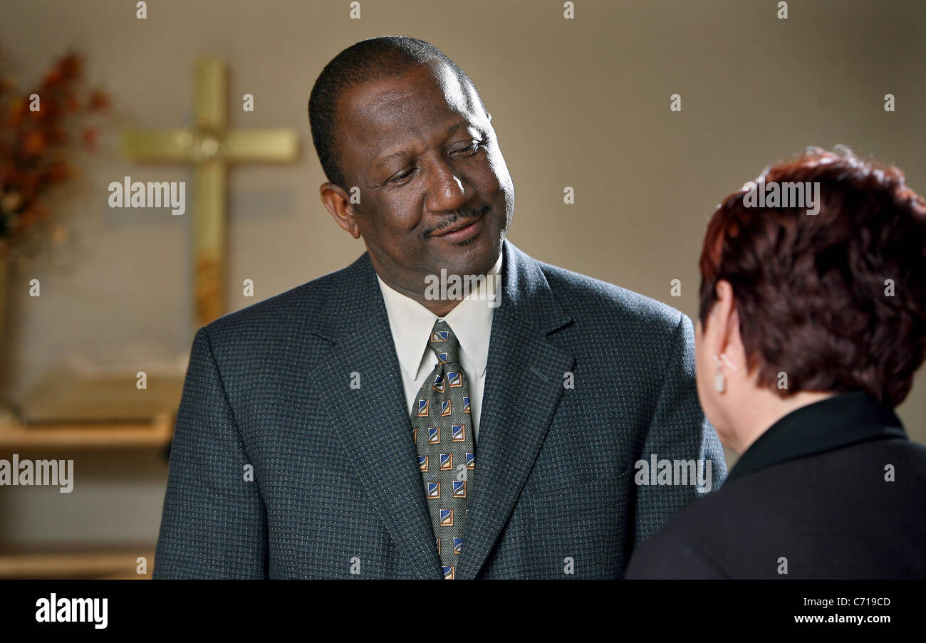 A pastor listens to a member of his congregation Stock Photo - Alamy