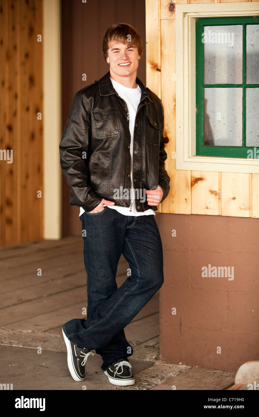 A man smiles for his portrait in a rustic setting Stock Photo - Alamy