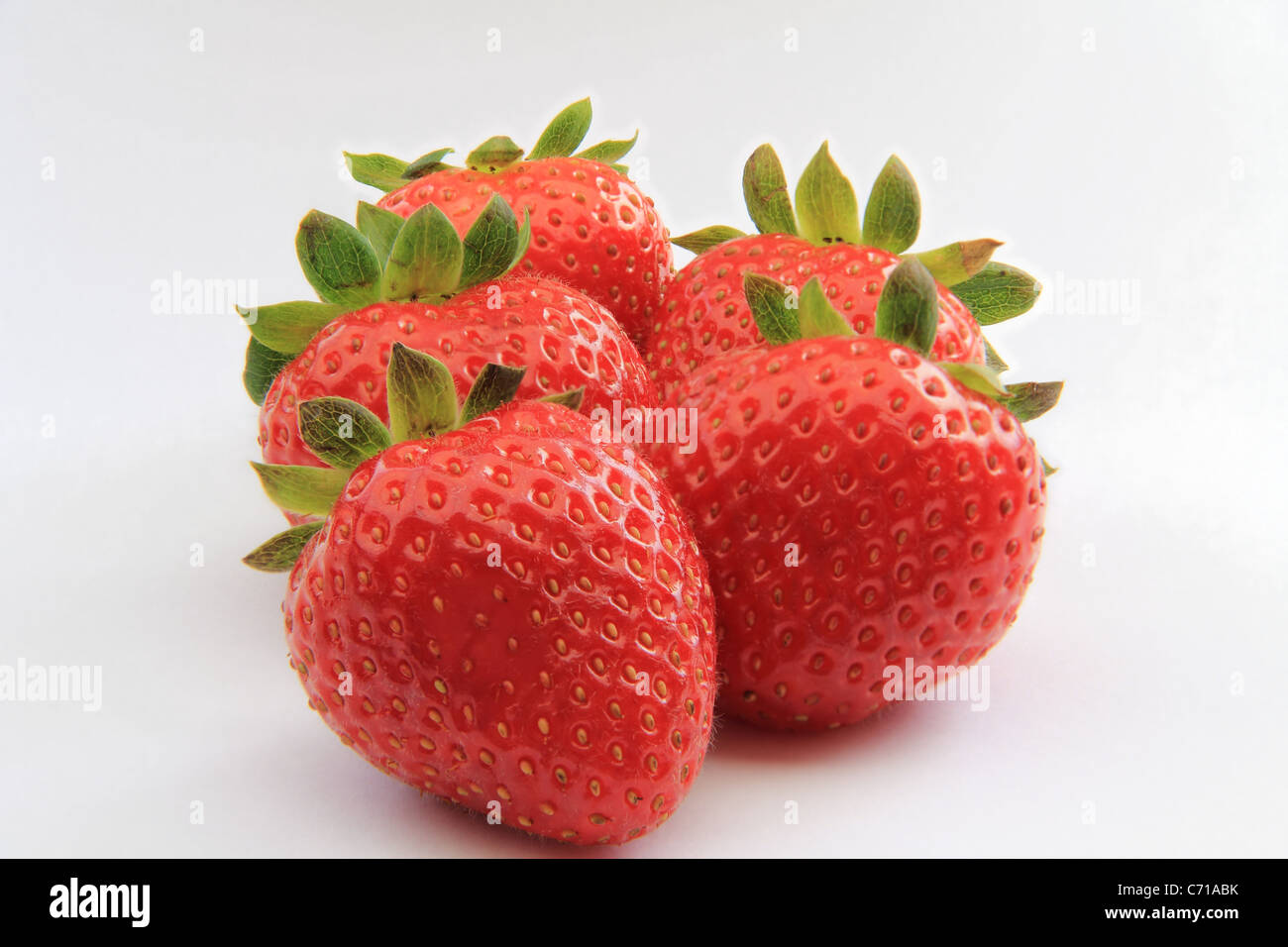 five delicious ripe strawberries on white background Stock Photo - Alamy